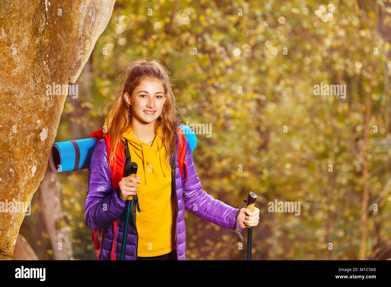 Beautiful hiker, woman with trekking poles and backpack on the mountain ...