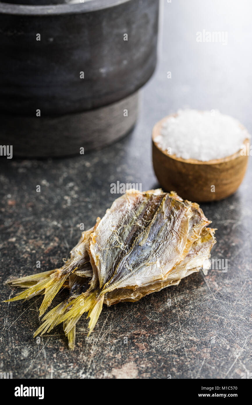 Dried salted fish on old kitchen table Stock Photo - Alamy