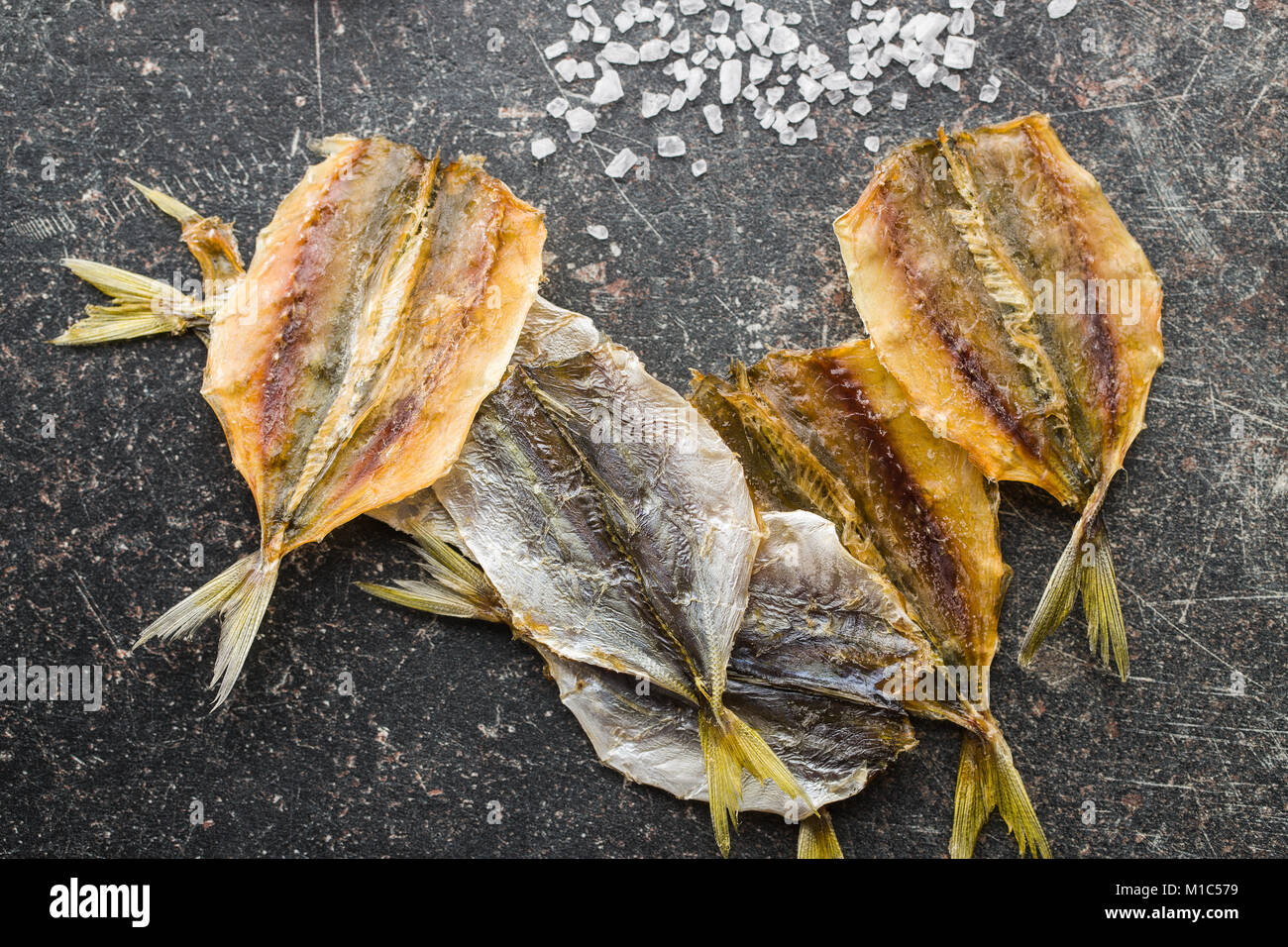 Dried salted fish on old kitchen table Stock Photo - Alamy