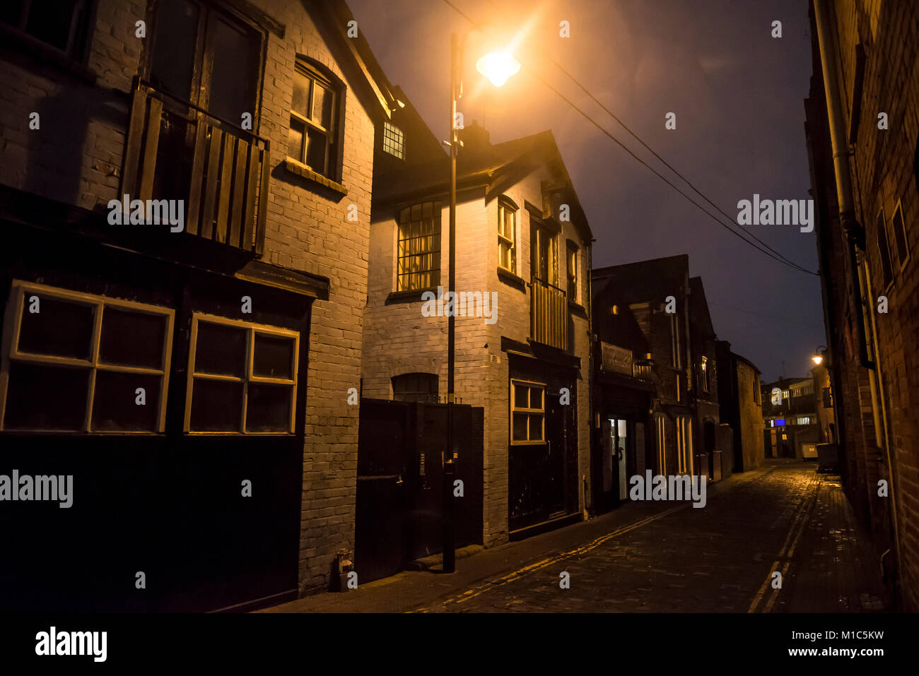 Narrow street at night with illuminated street lamp, Wolverhampton ...