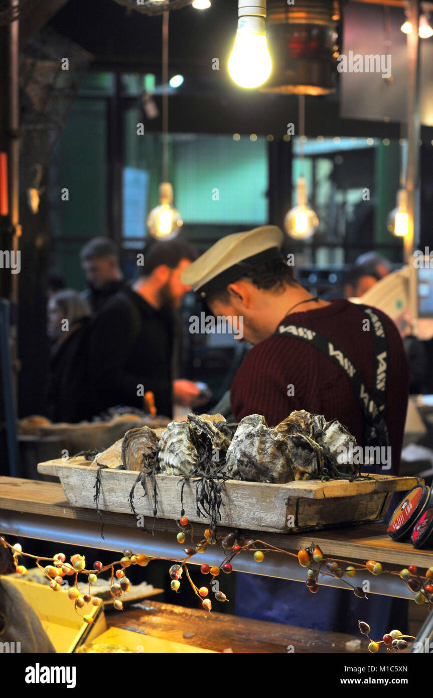 A man wearing a sailors hat at borough market in central london on a ...