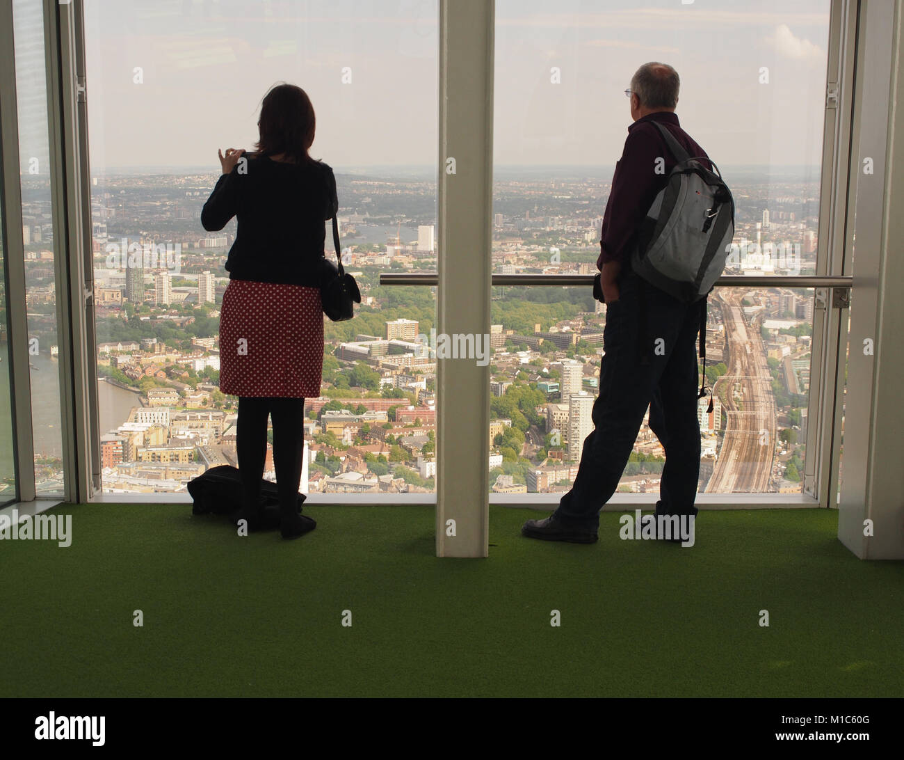 A man and a woman looking over east London from the highest viewing ...