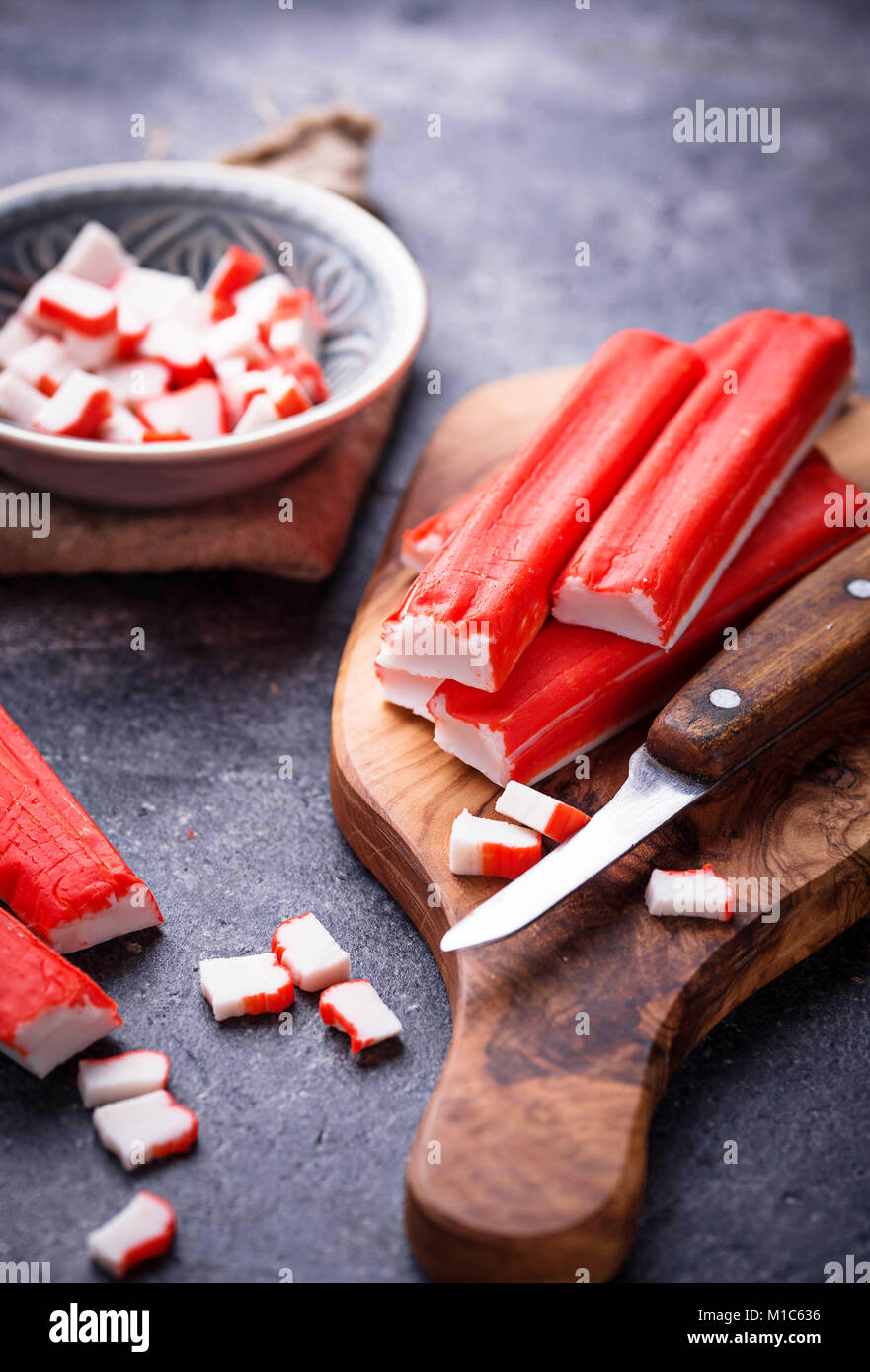 Crab sticks surimi and knife. Selective focus Stock Photo - Alamy