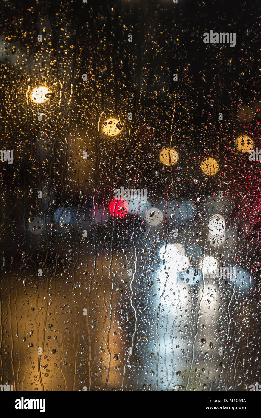 Traffic lights seen through a rainy glass pane Stock Photo - Alamy