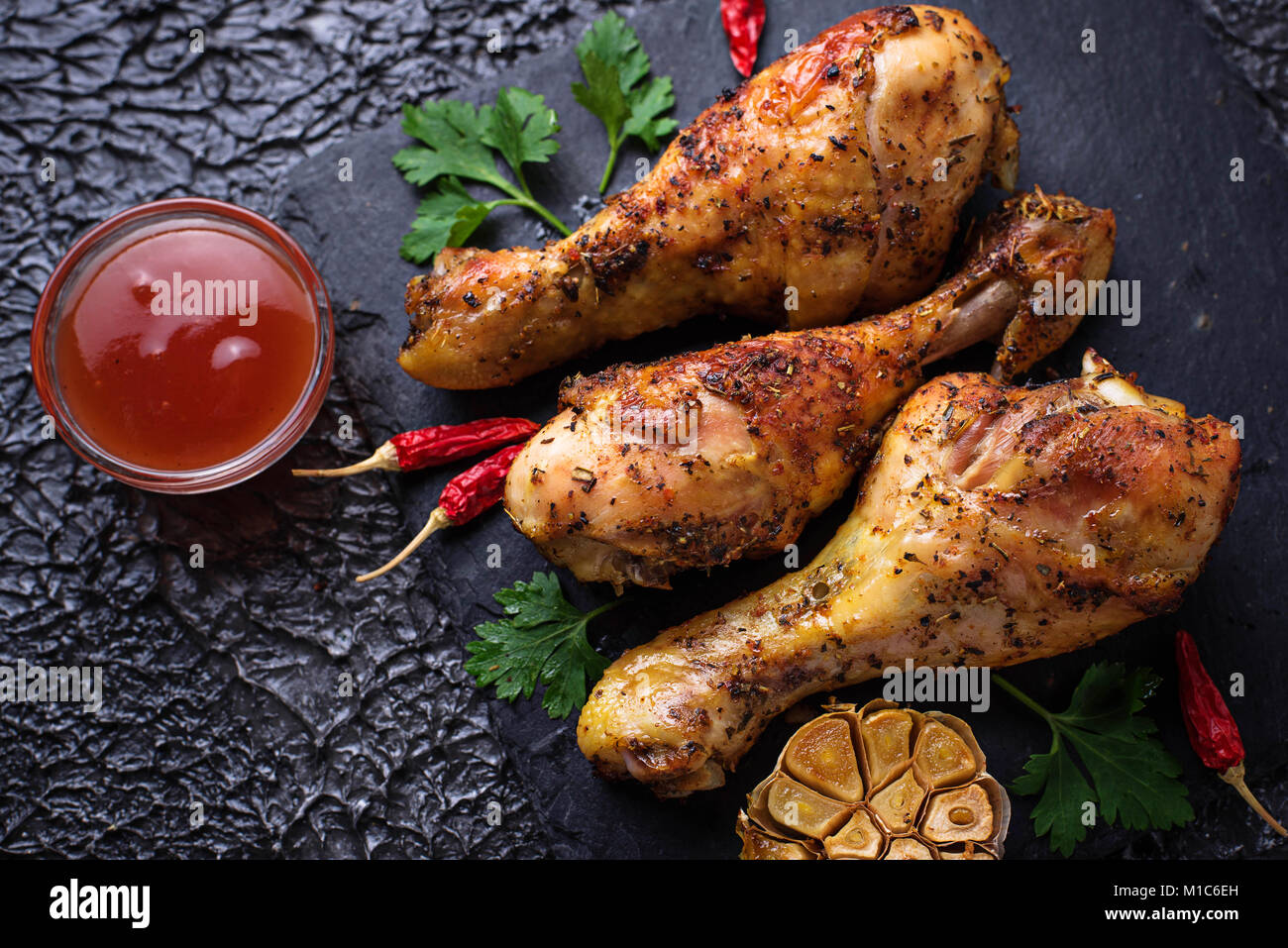 Grilled chicken legs with spices and garlic. Top view Stock Photo - Alamy