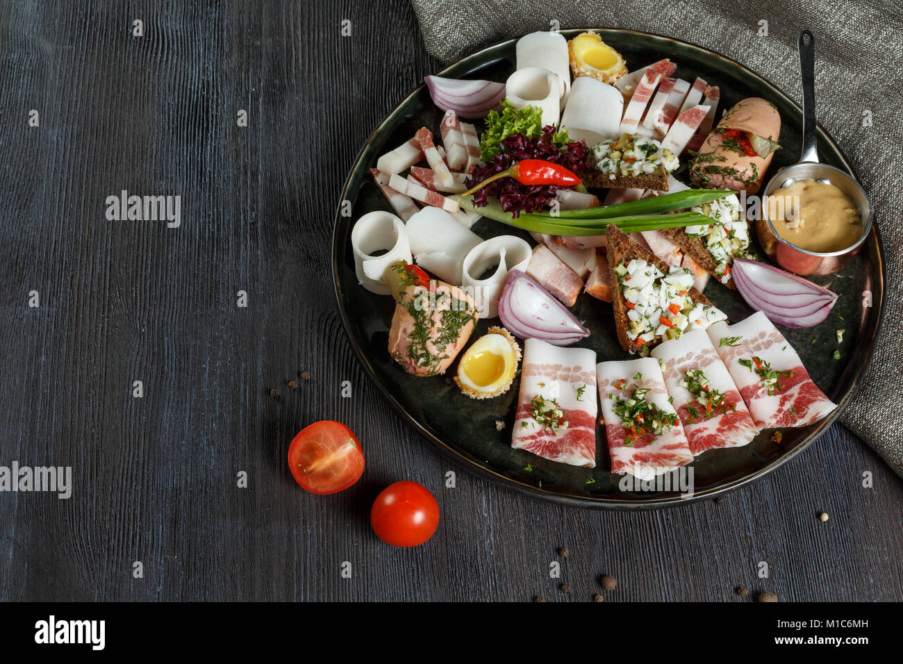 Lard plate with salt cucumbers and marinated garlic Stock Photo - Alamy