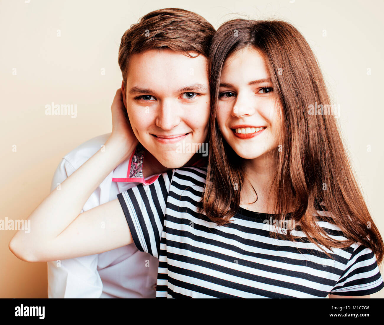 couple of happy smiling teenagers students, warm colors having a Stock ...