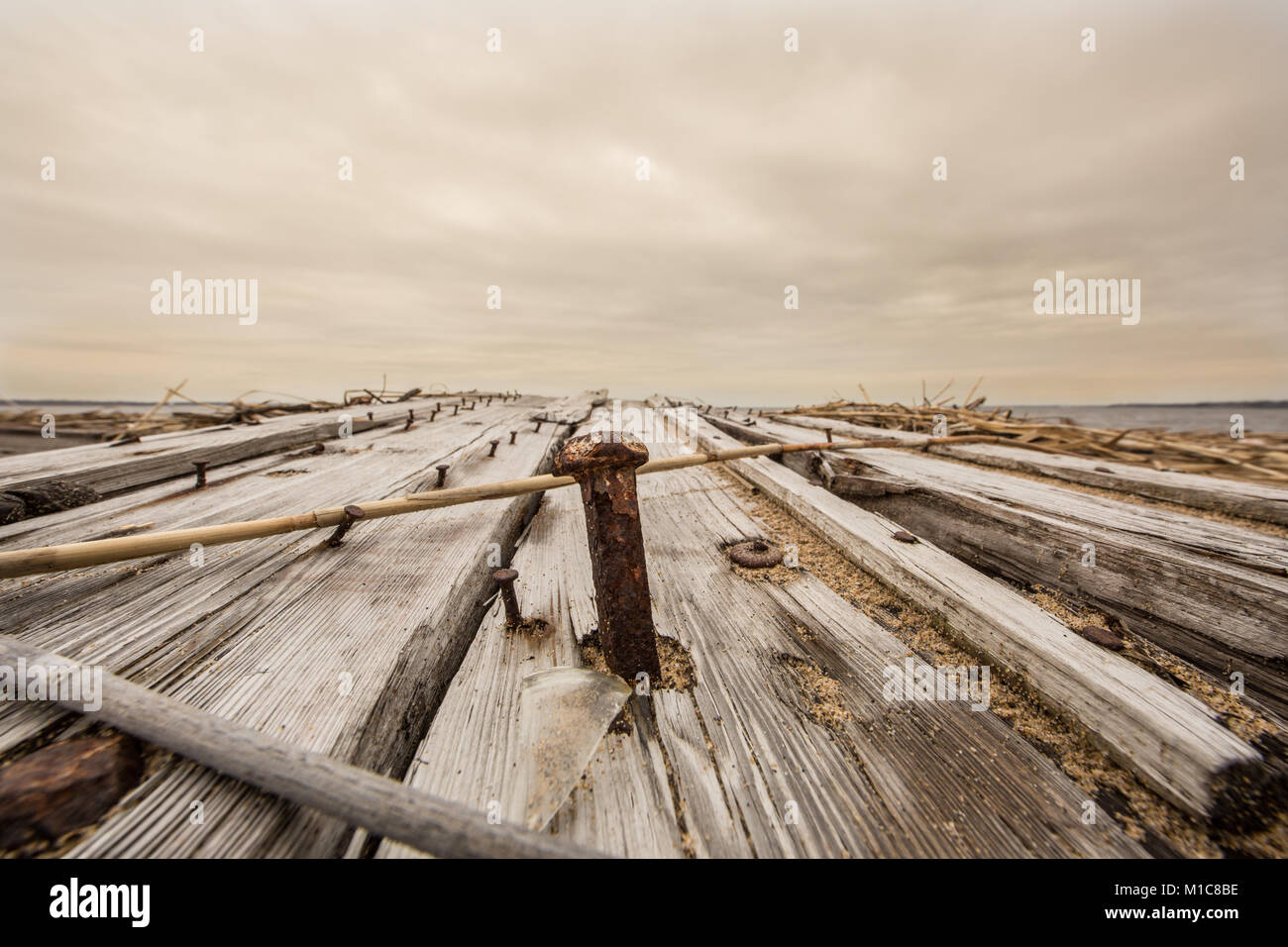 Washed up boardwalk on beach Stock Photo - Alamy