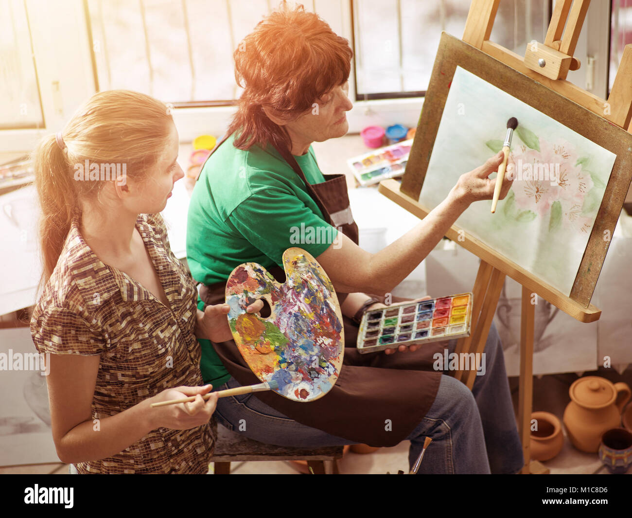 Artist painting on easel in studio. Authentic children paints Stock ...