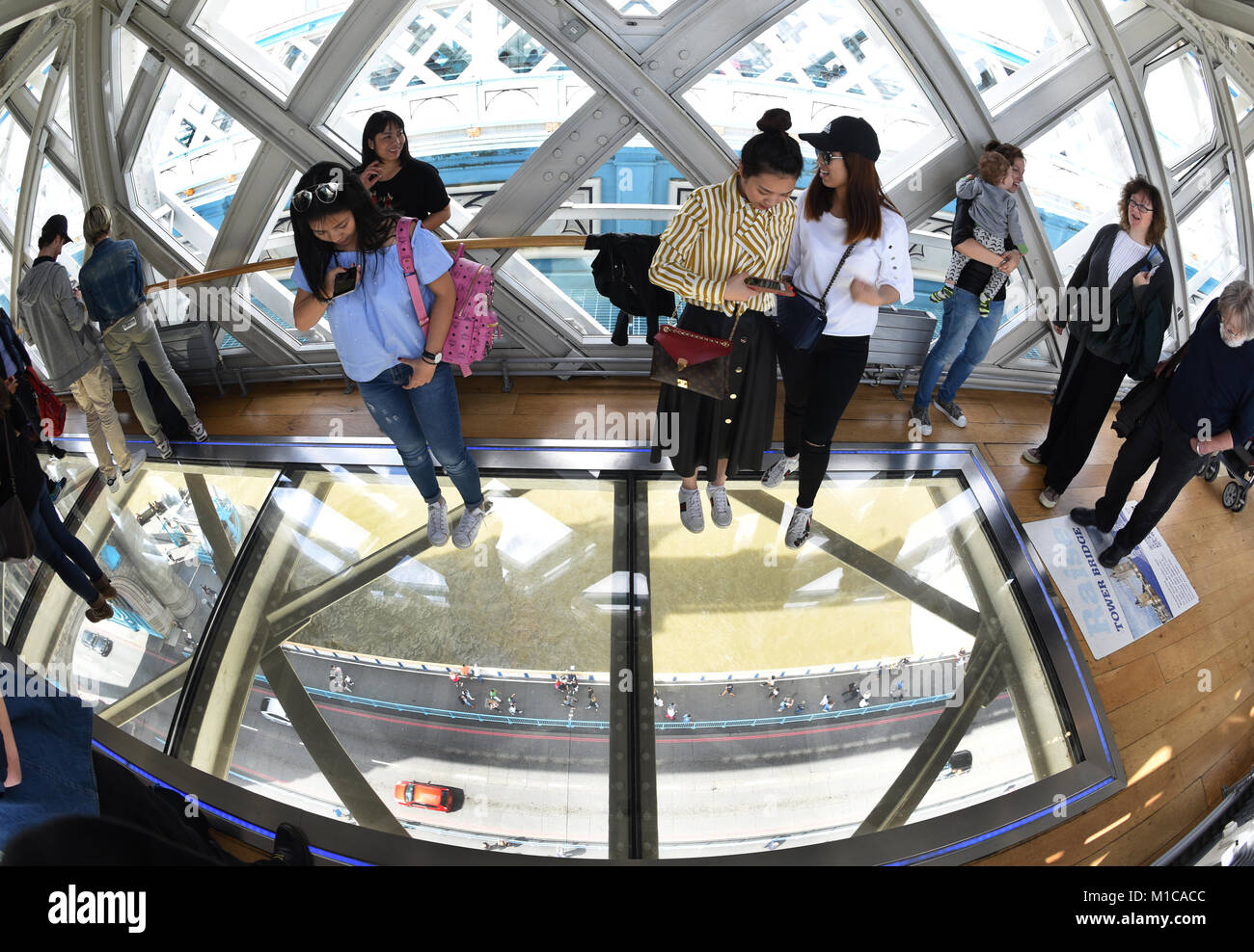 Tourists take pictures inside the tower bridge in London, England, 20 ...