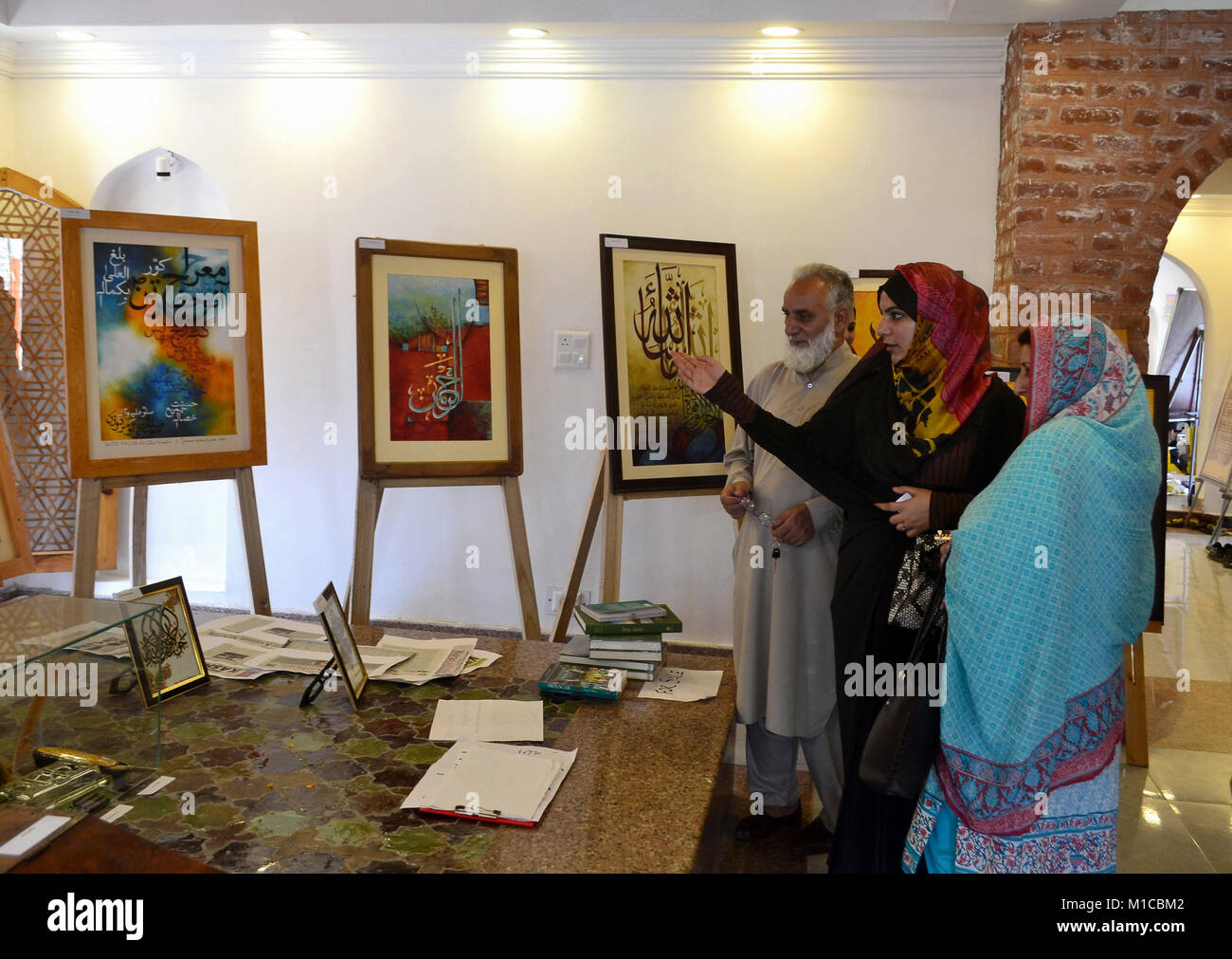 Srinagar, India. 23rd July, 2017. Visitors look at Islamic calligraphy ...