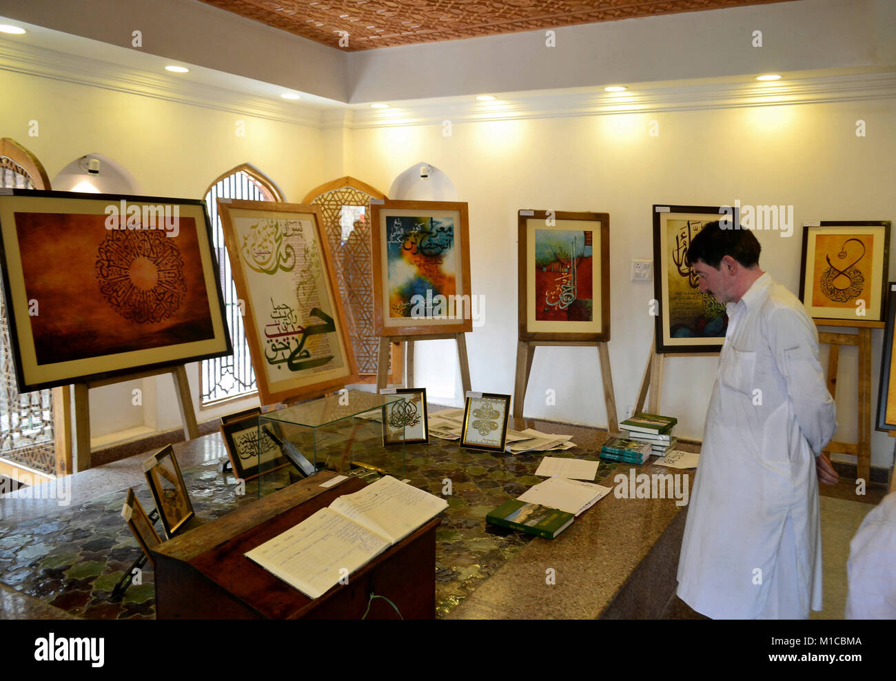 Srinagar, India. 23rd July, 2017. A visitor looks at Islamic ...