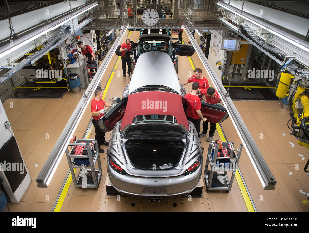 Employees work on a car of the model 718 Boxster at a manufacturing ...