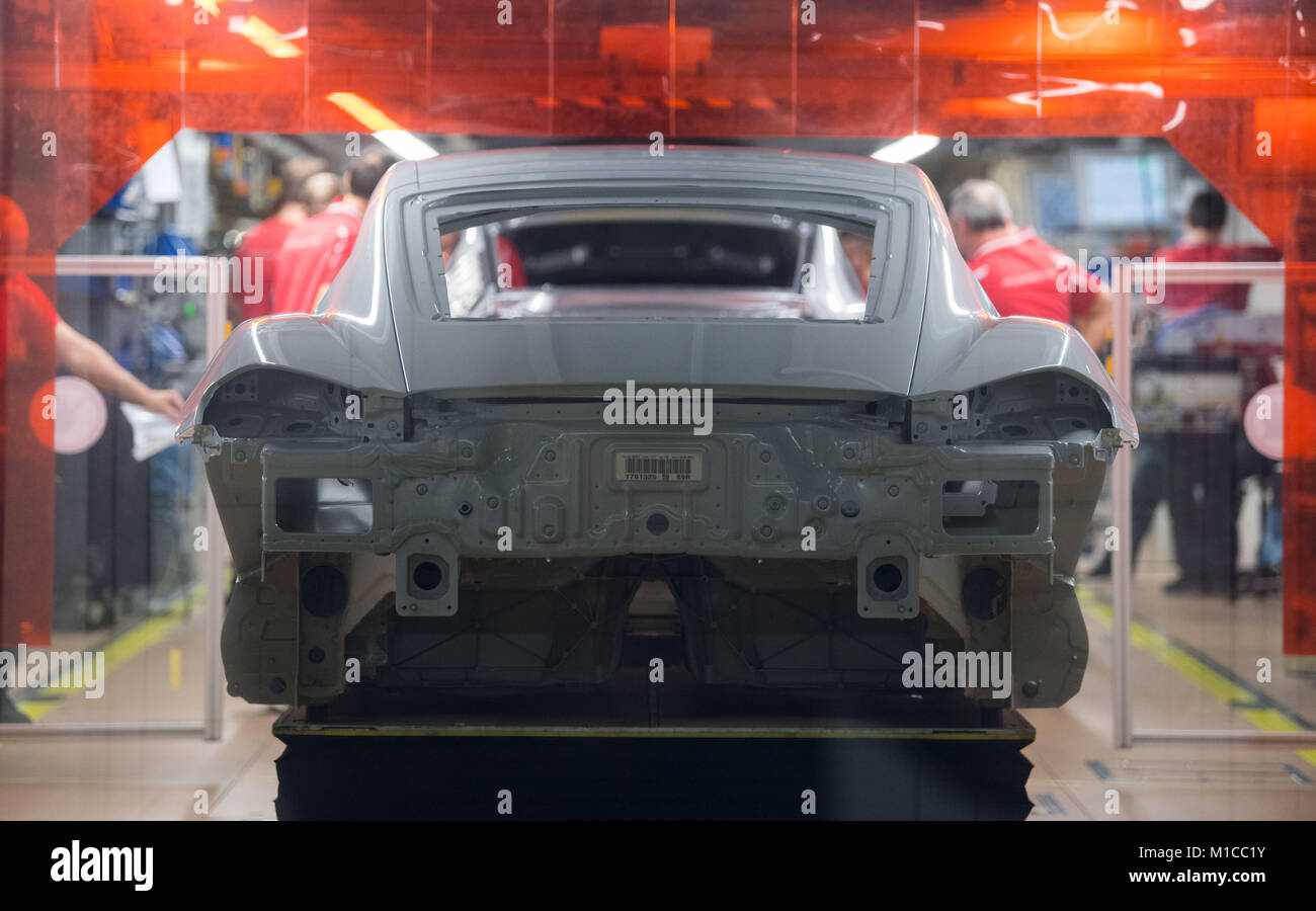 Employees work on a car of the model 718 Cayman at a manufacturing ...