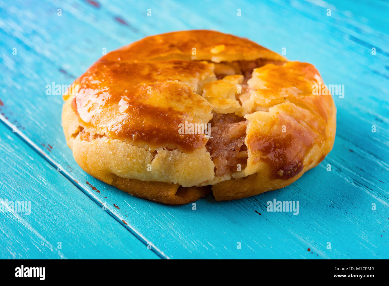 side view sweet mini chewy cakes or chickee cakes on blue wood ...