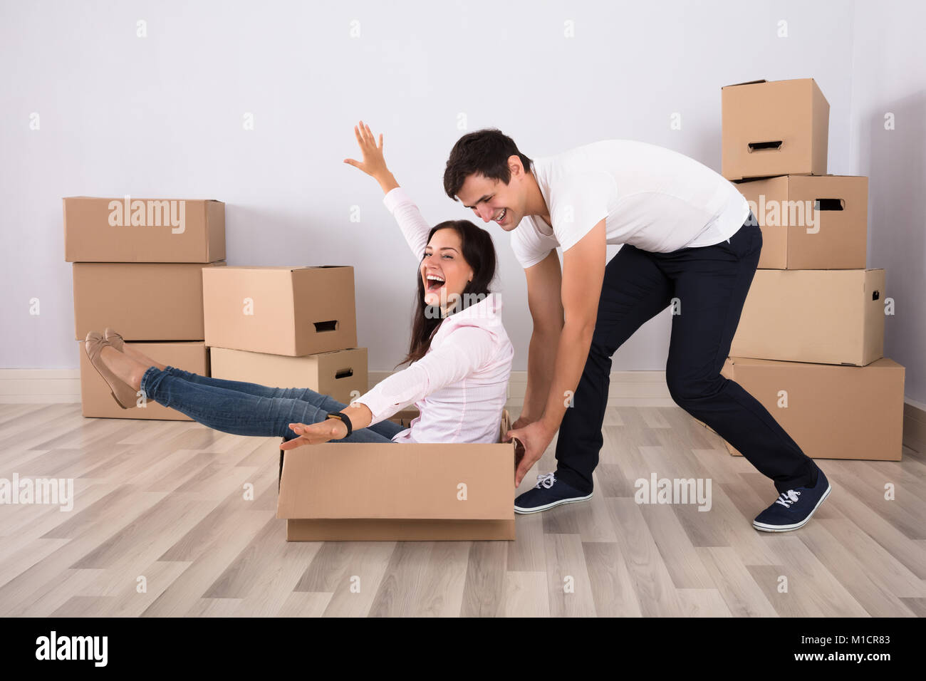 Woman sitting inside cardboard box hi-res stock photography and images ...