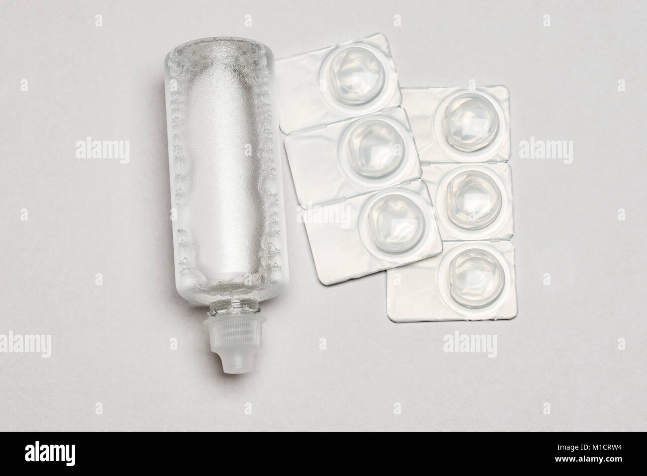 Contact lens solution and contact lens packages on white background ...