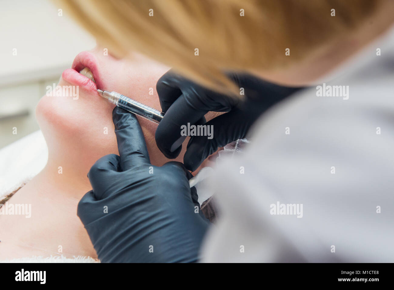 Contour plastic: Dermatologist doctor inject filler. Close up female ...