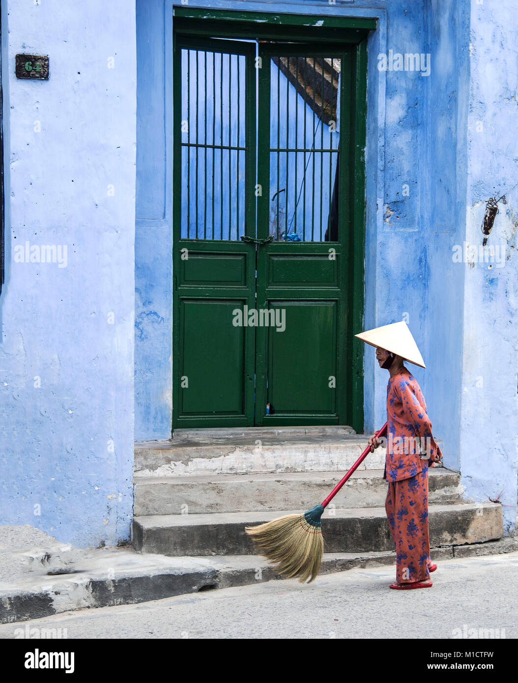 Lady in street with broom hi-res stock photography and images - Alamy