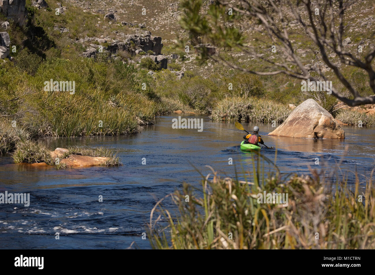 Woman kayaking in river Stock Photo - Alamy