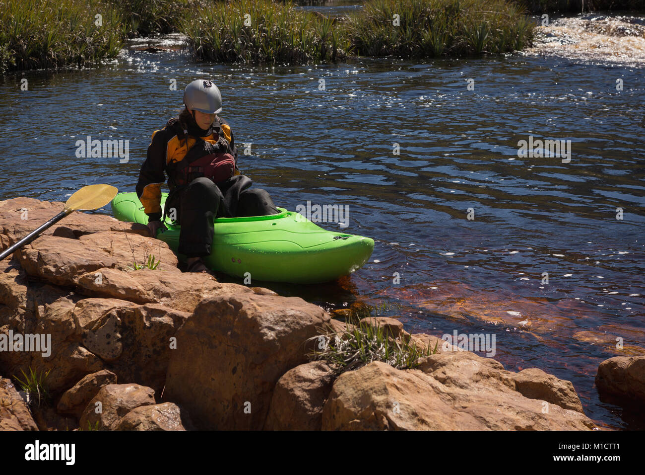 Woman kayaking in river Stock Photo - Alamy