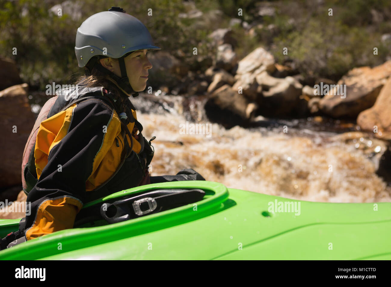 Woman kayaking in river Stock Photo - Alamy