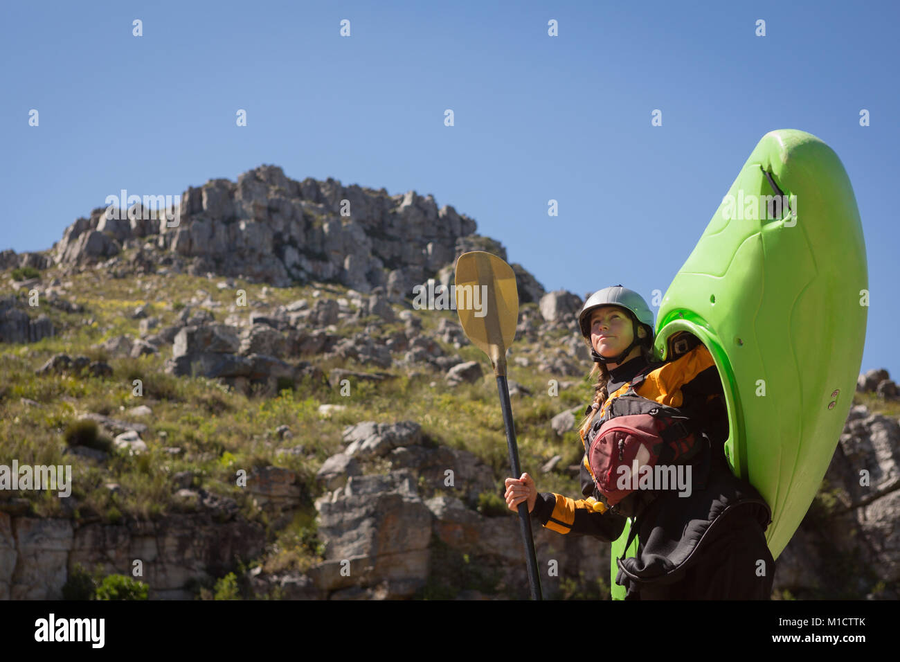 Woman walking with kayak boat Stock Photo - Alamy