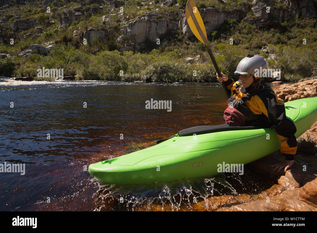 Woman kayaking in river Stock Photo - Alamy
