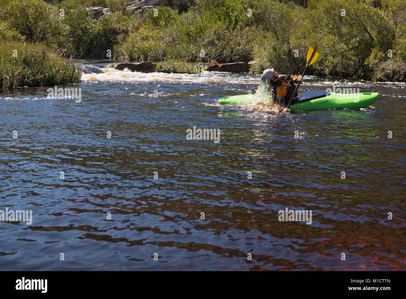 Woman kayaking in river Stock Photo - Alamy
