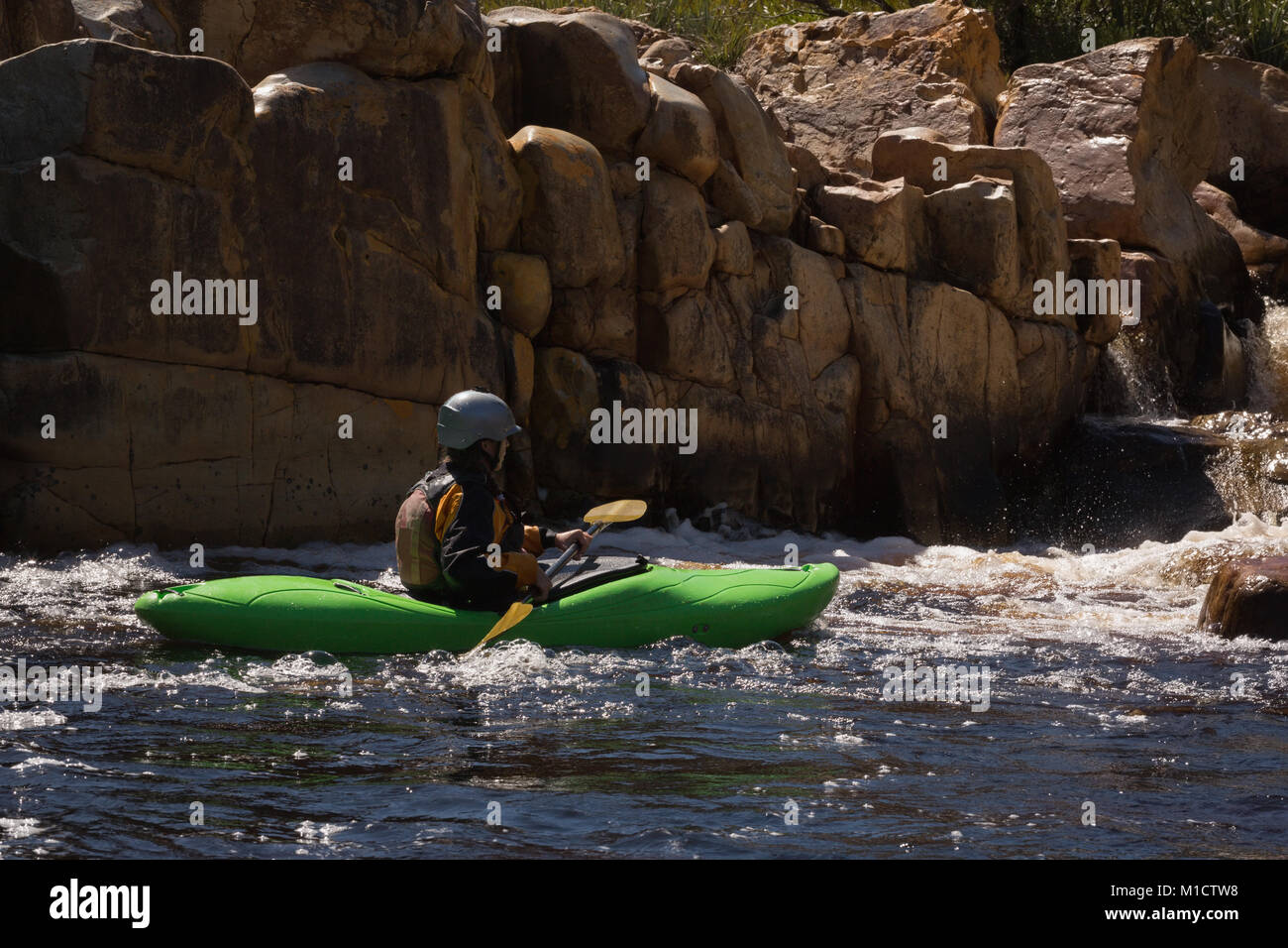 Woman kayaking in river Stock Photo - Alamy