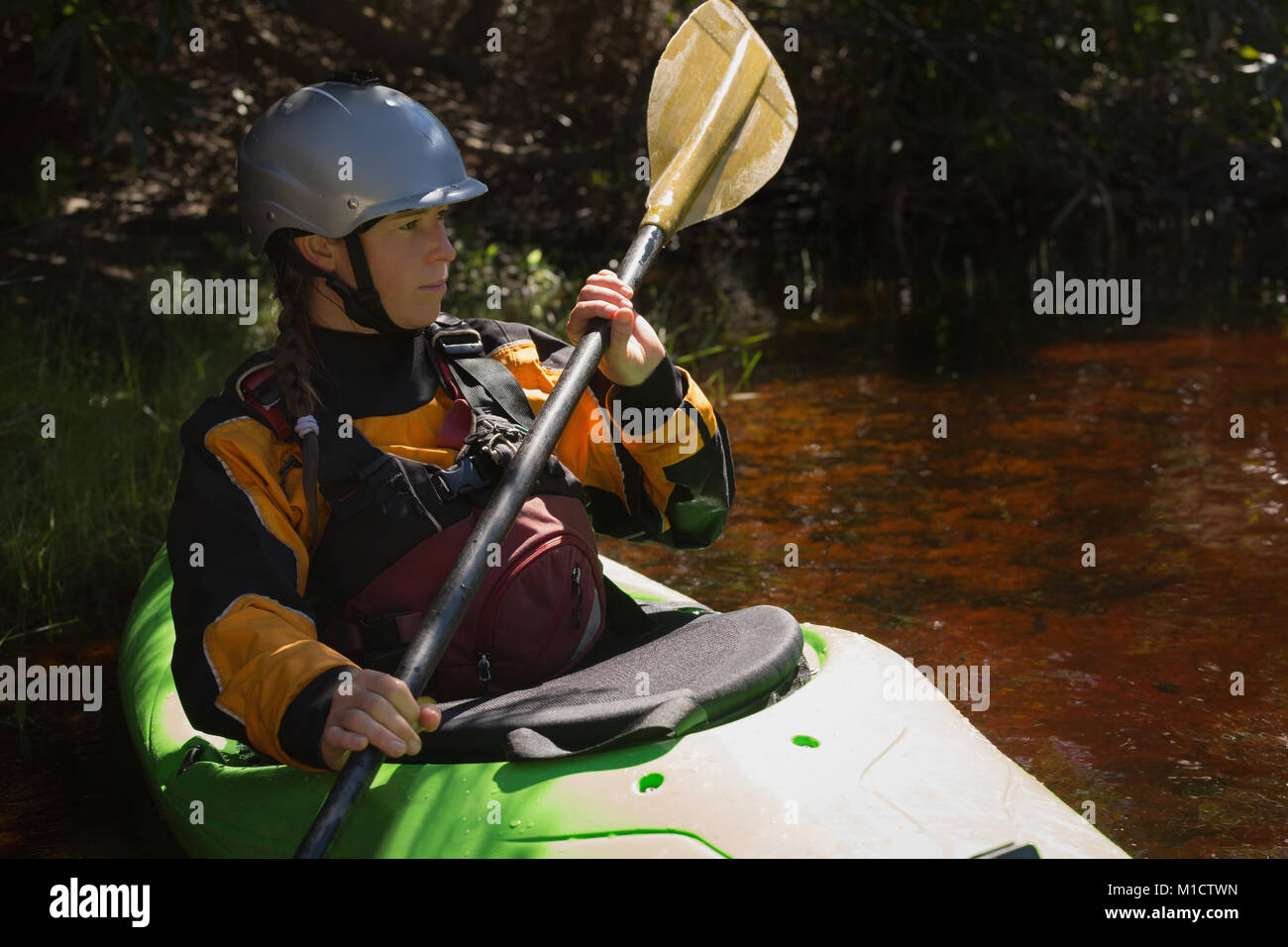 Woman kayaking in river Stock Photo - Alamy