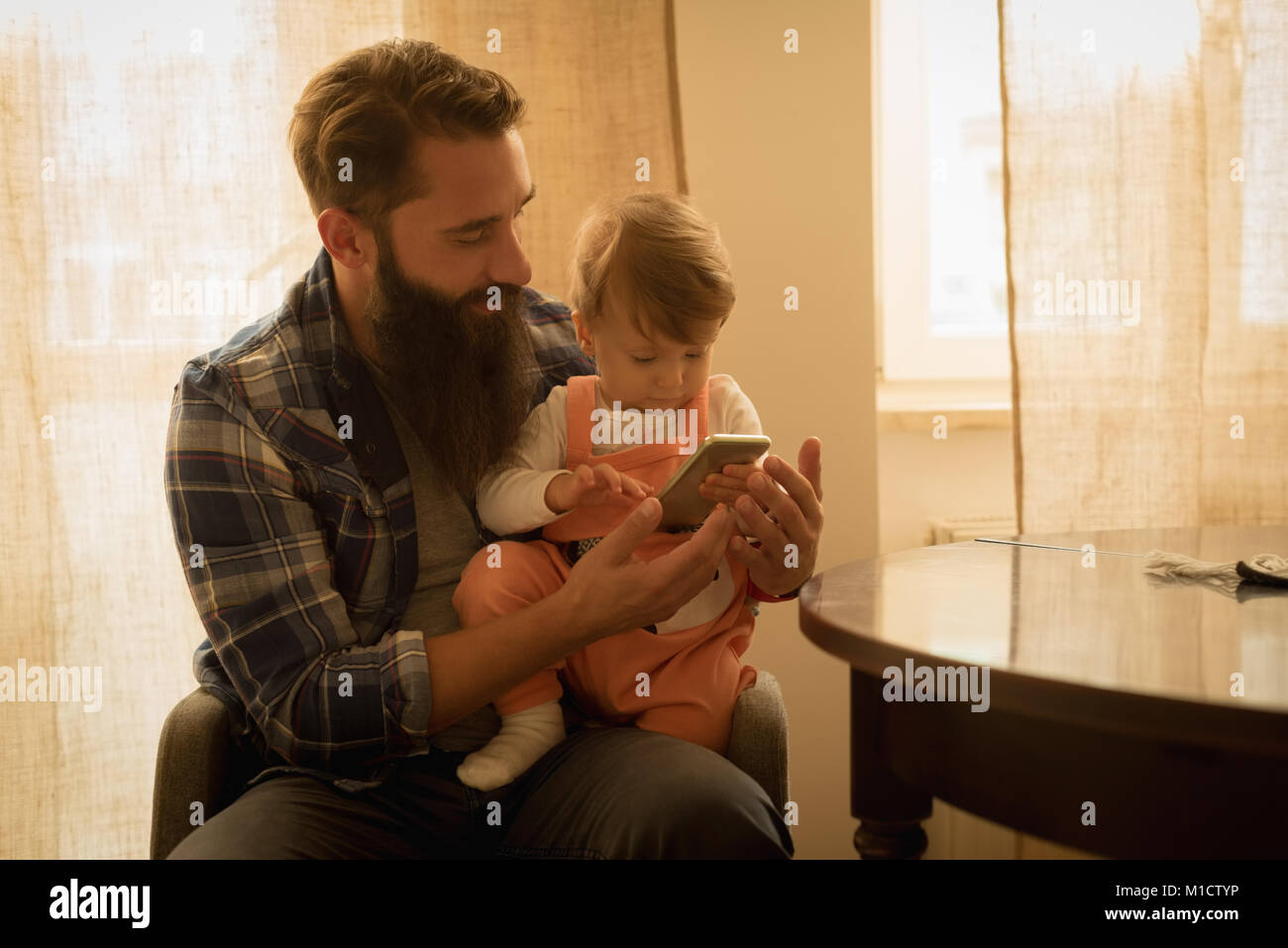 Father and son using mobile phone Stock Photo - Alamy