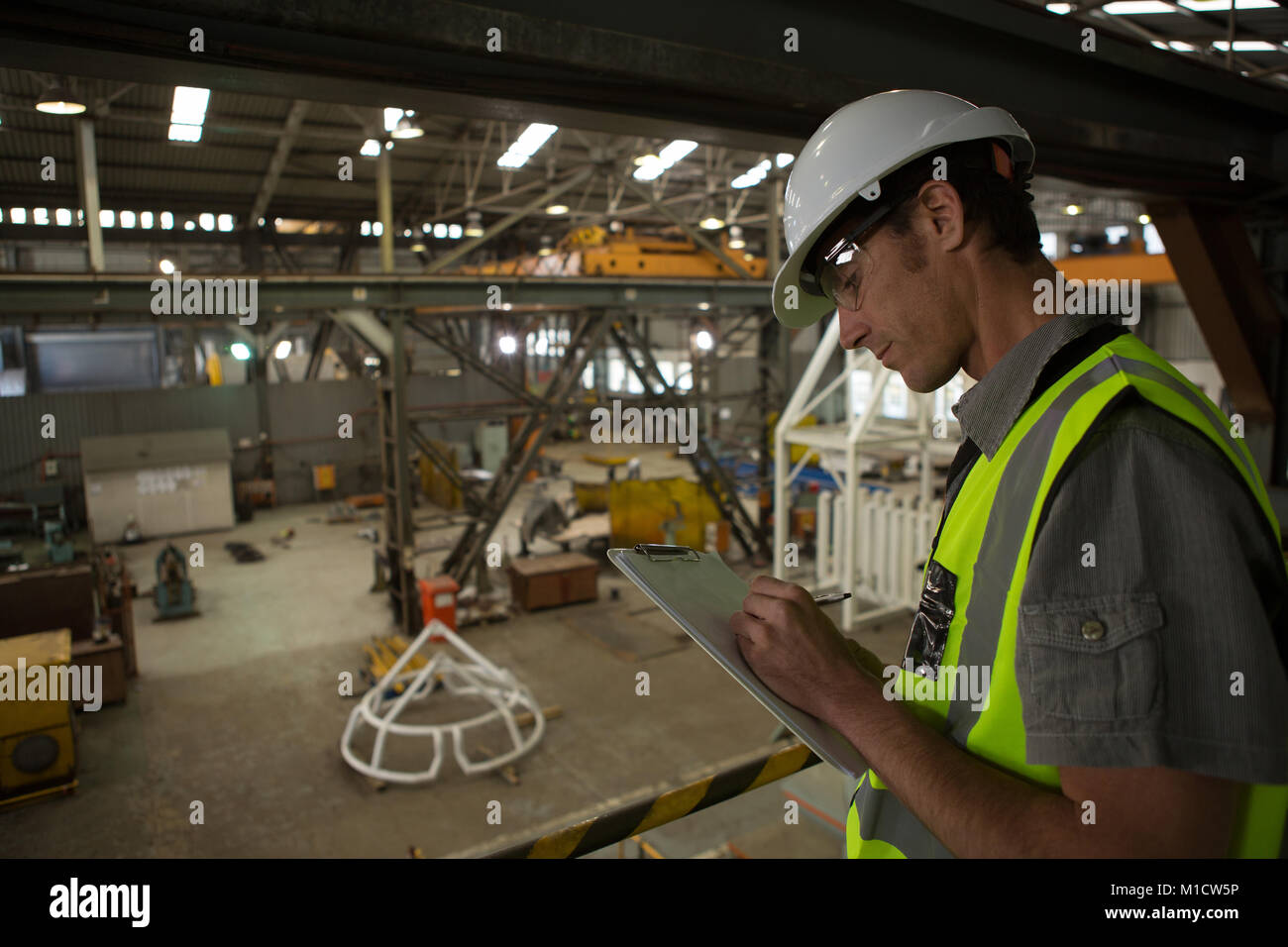 Marine engineer writing on clipboard Stock Photo - Alamy
