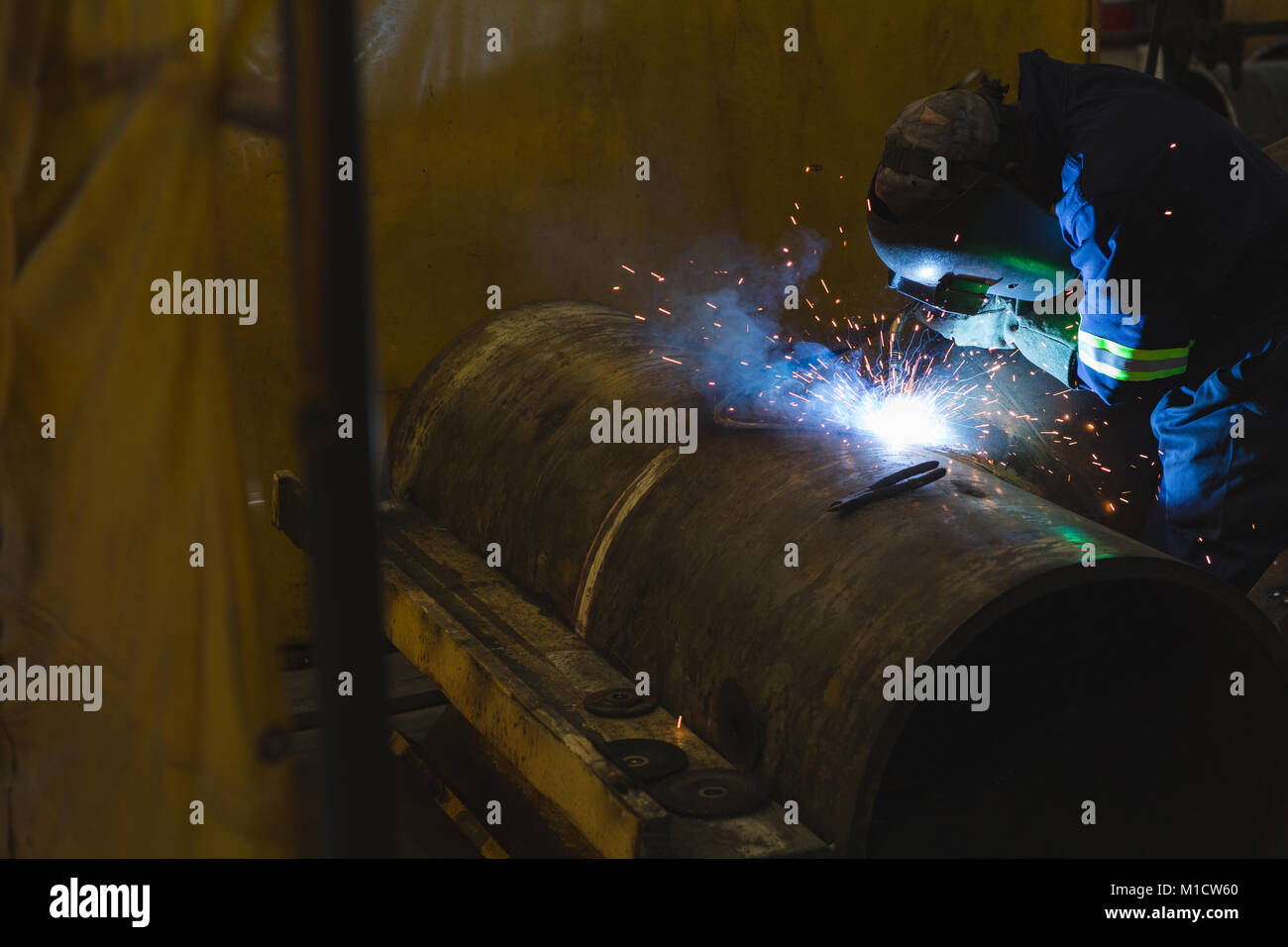 Welder repairing vessel part Stock Photo - Alamy