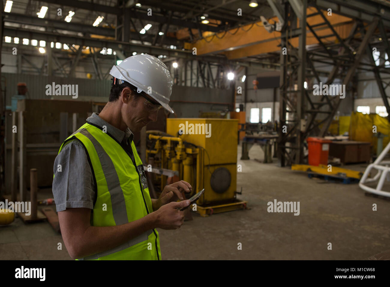Marine engineer using mobile phone Stock Photo - Alamy