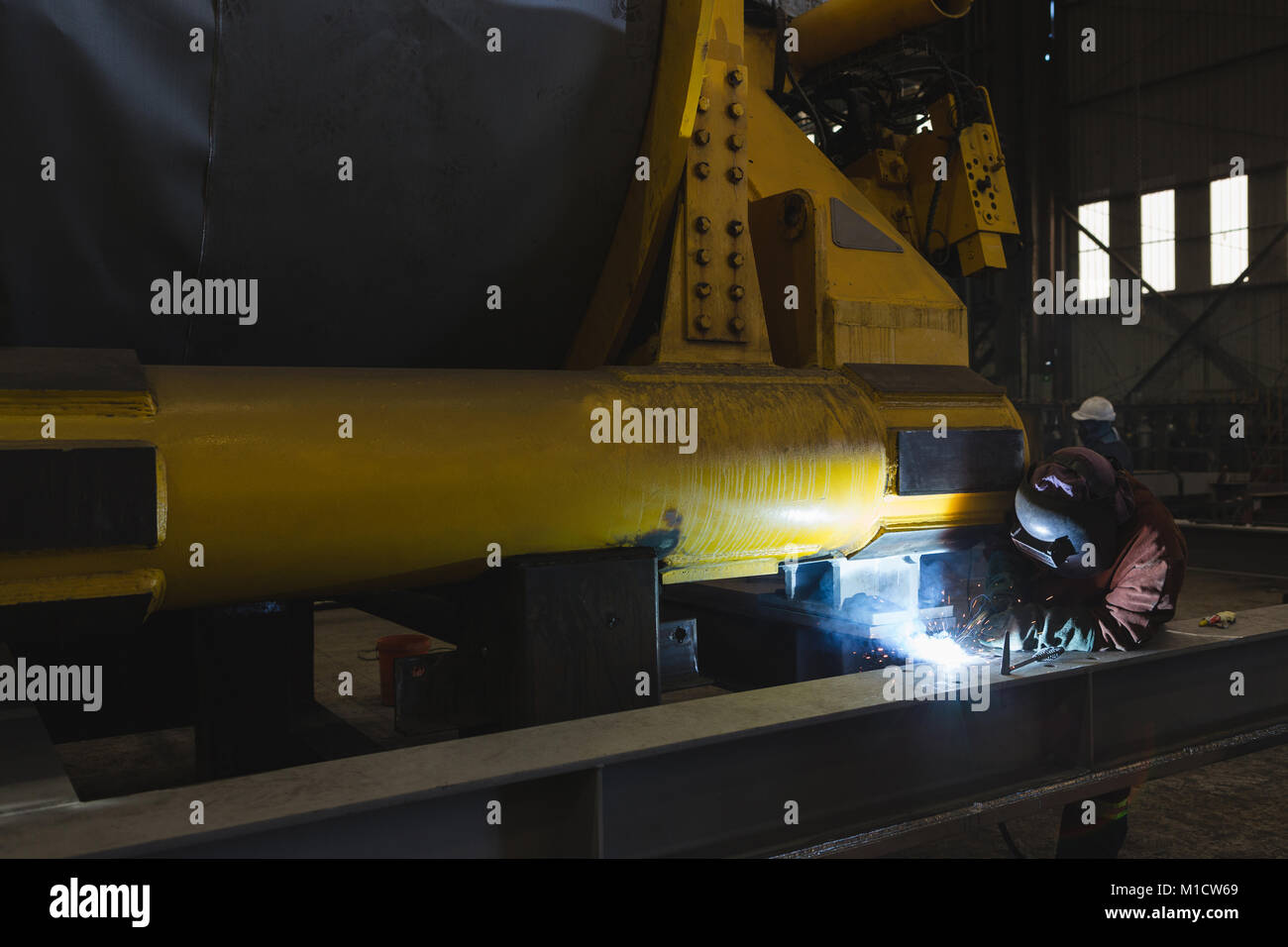 Welder repairing vessel part Stock Photo - Alamy