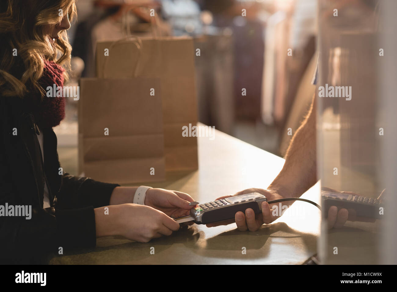 Woman making payment through mobile phone Stock Photo - Alamy
