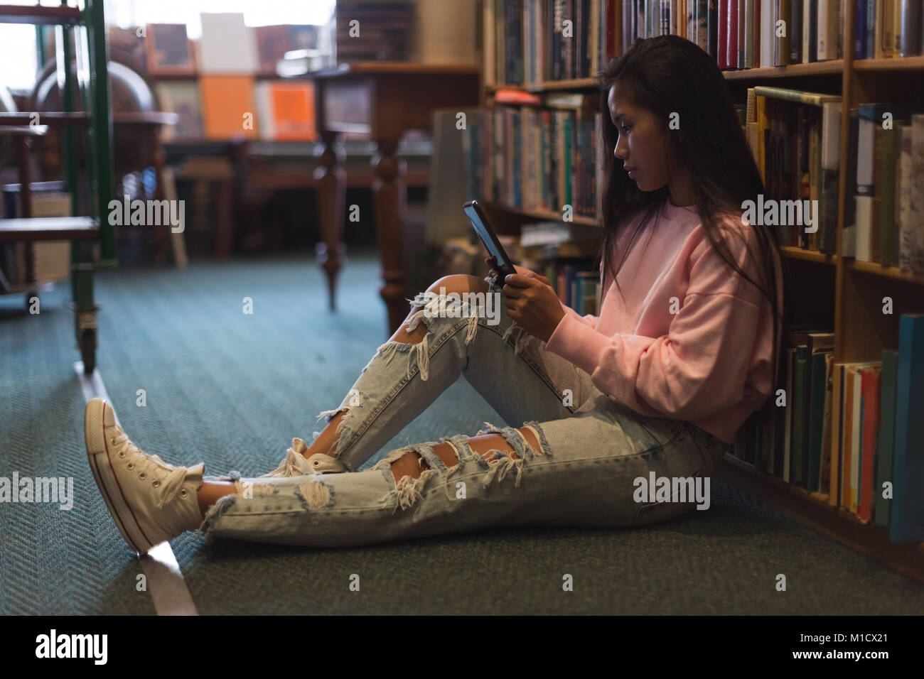 Teenage girl using digital tablet Stock Photo - Alamy