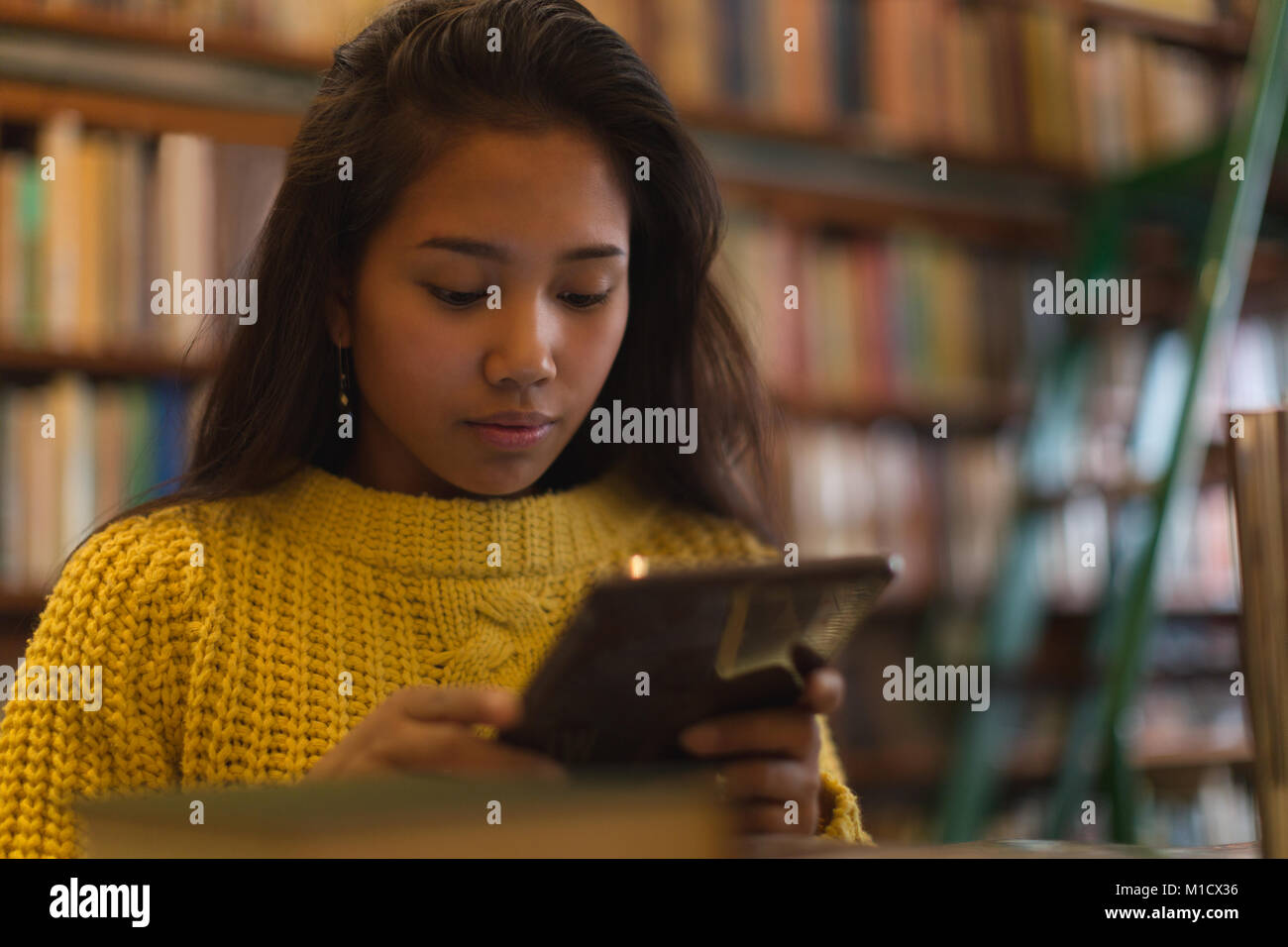 Teenage girl using digital tablet Stock Photo - Alamy
