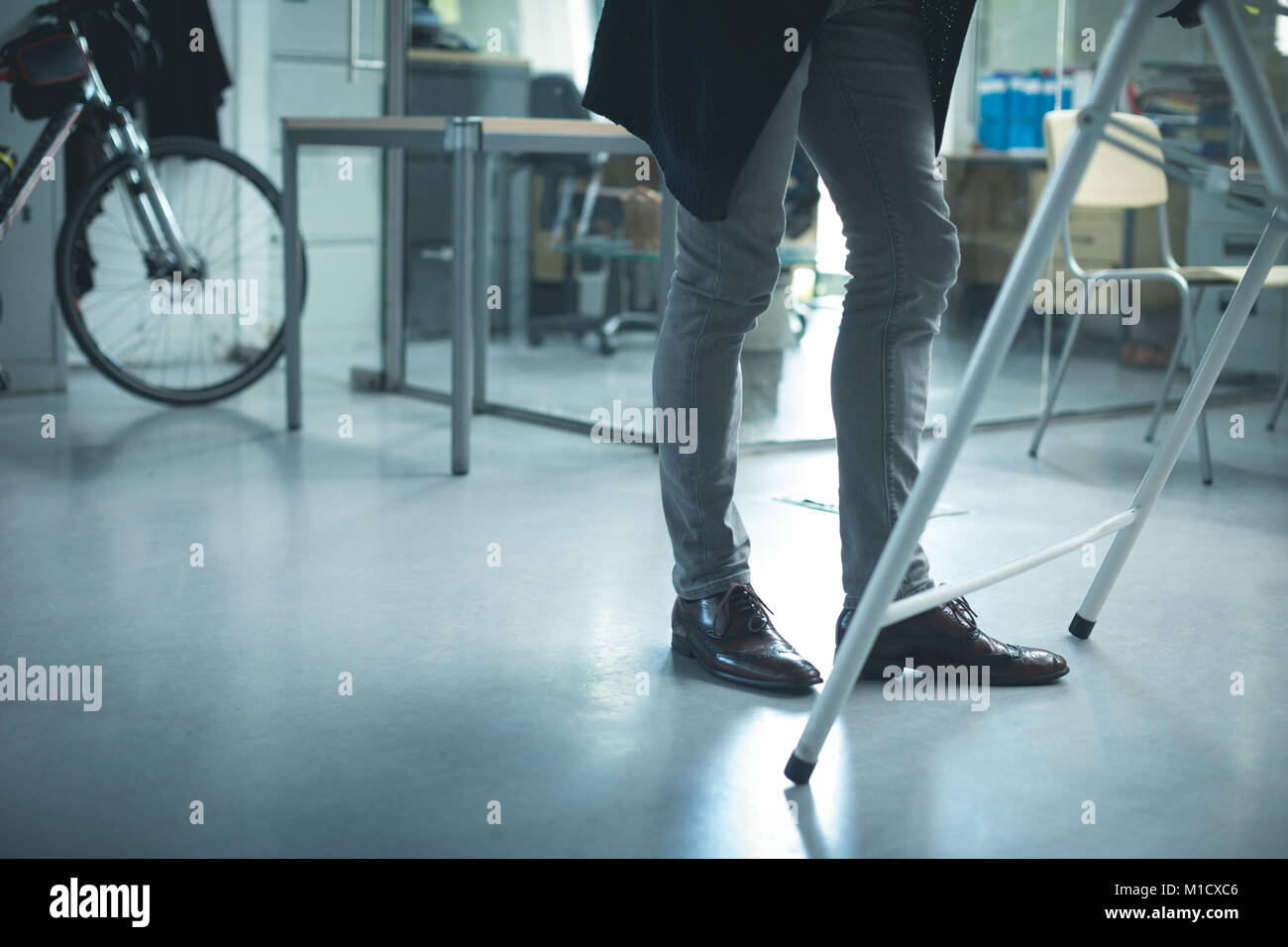 Executive standing in office Stock Photo - Alamy