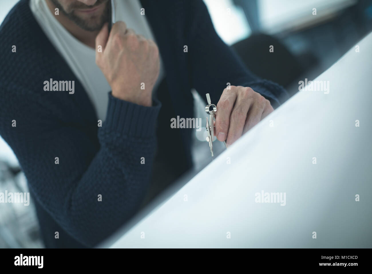 Executive working on blueprint Stock Photo - Alamy