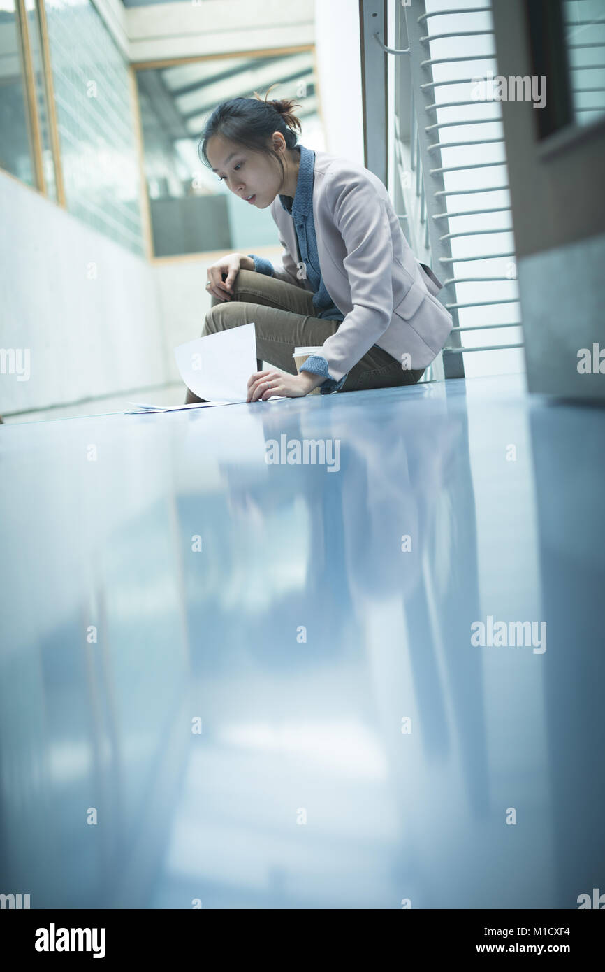 Female executive reading a document Stock Photo - Alamy