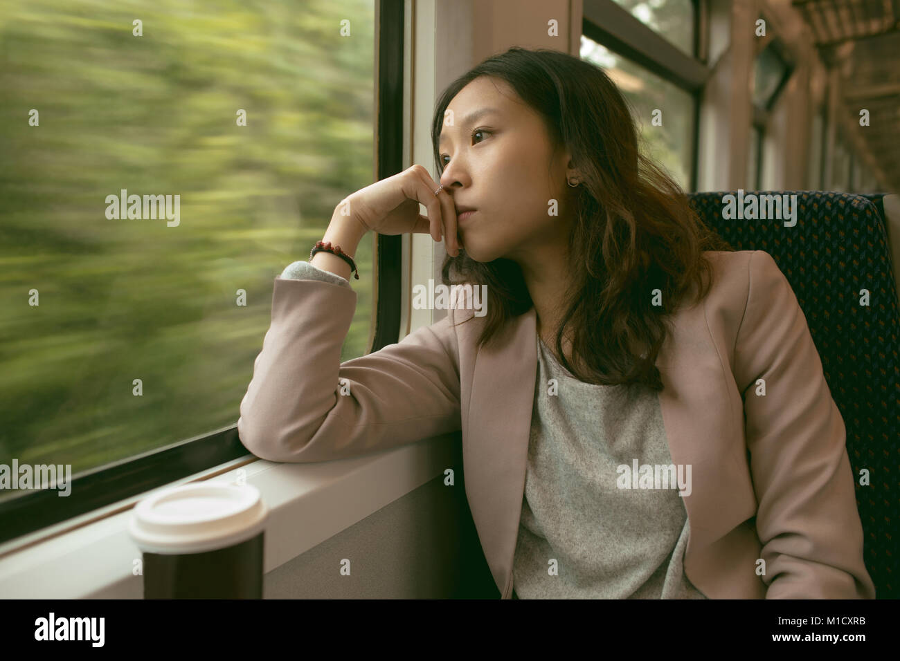 Thoughtful woman looking through window Stock Photo - Alamy Thoughtful woman looking through window Stock Photo - Alamy