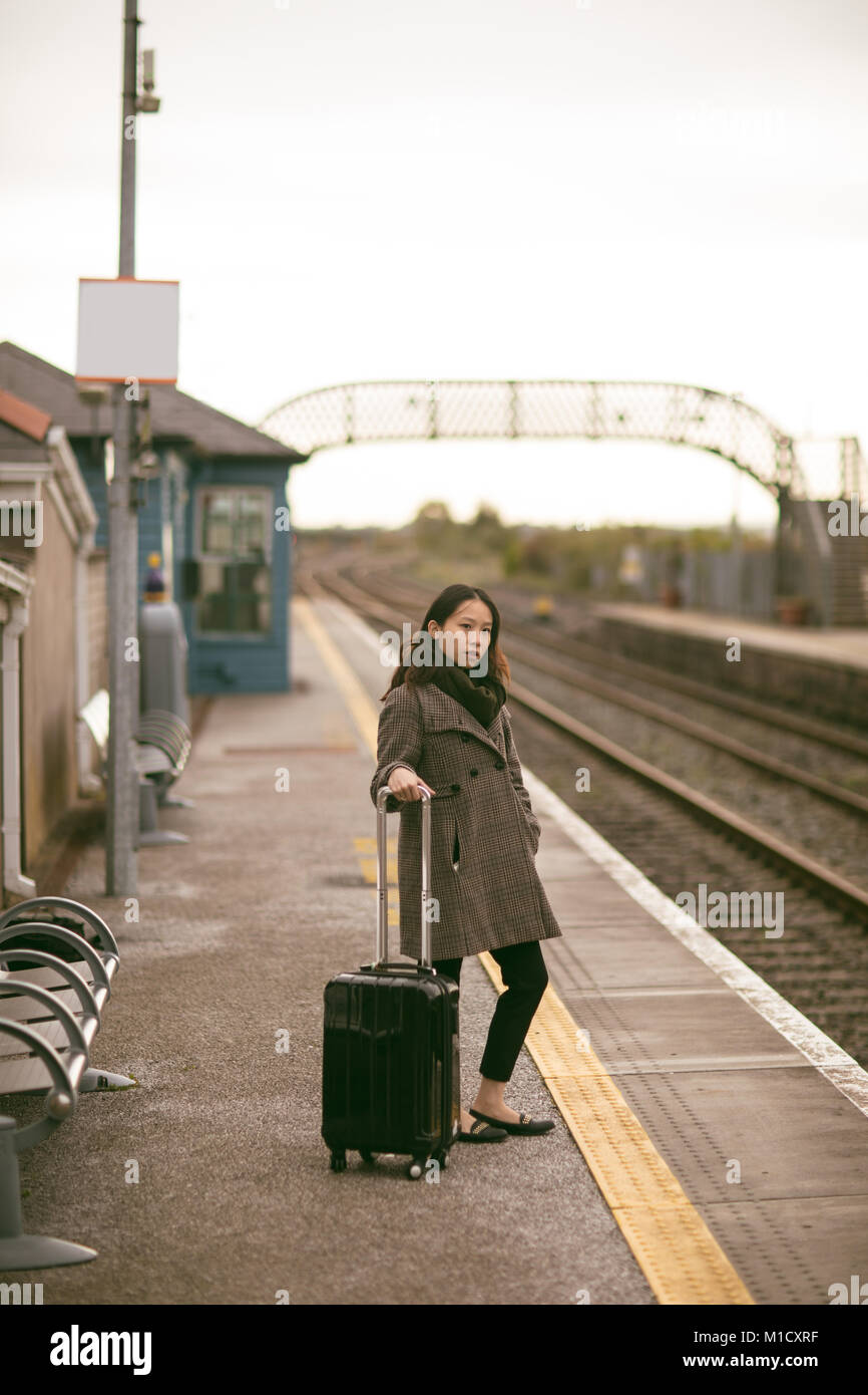 Woman waiting for the train hi-res stock photography and images - Alamy