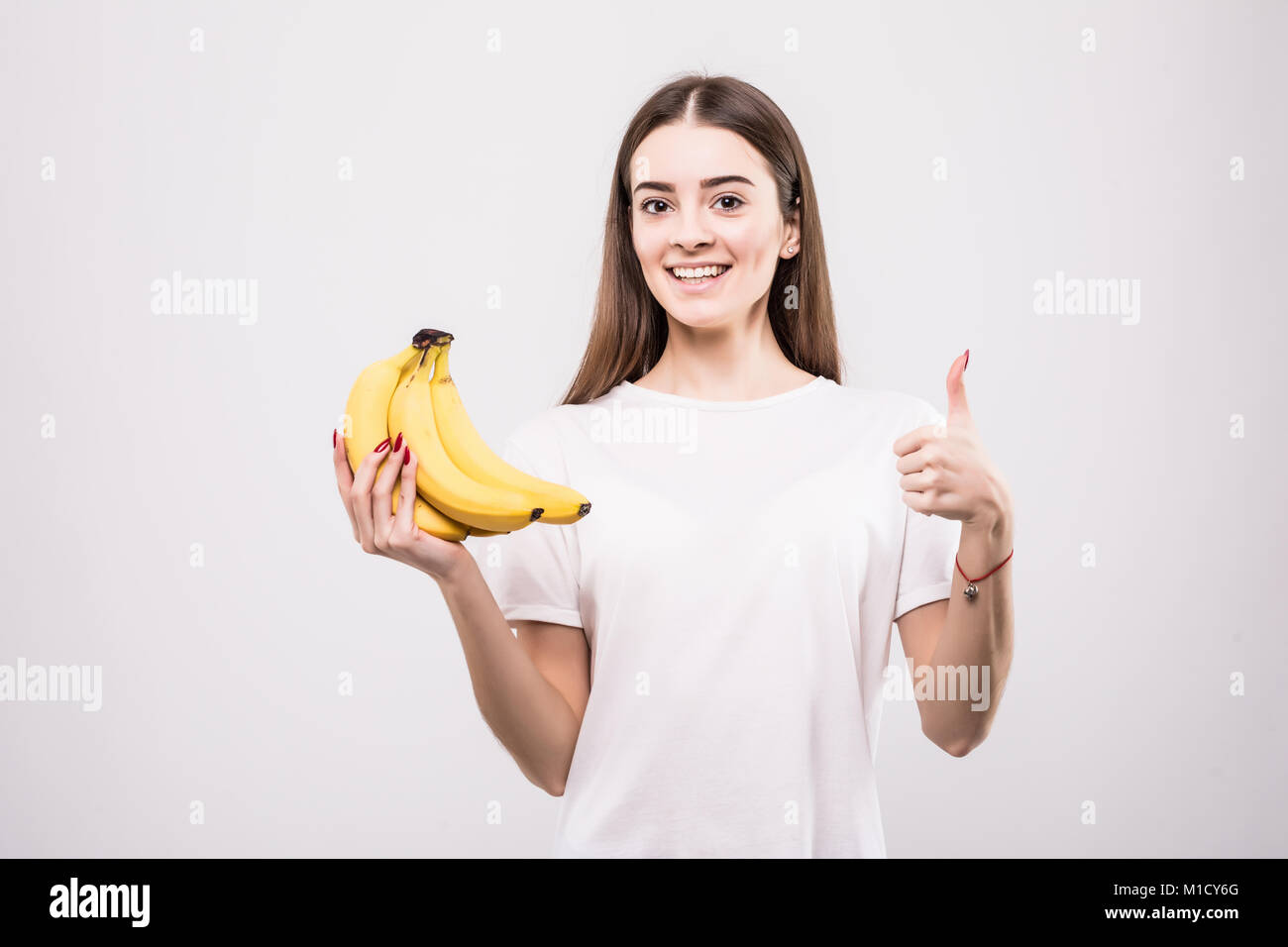 beautiful young woman with bananas isolated on white Stock Photo - Alamy
