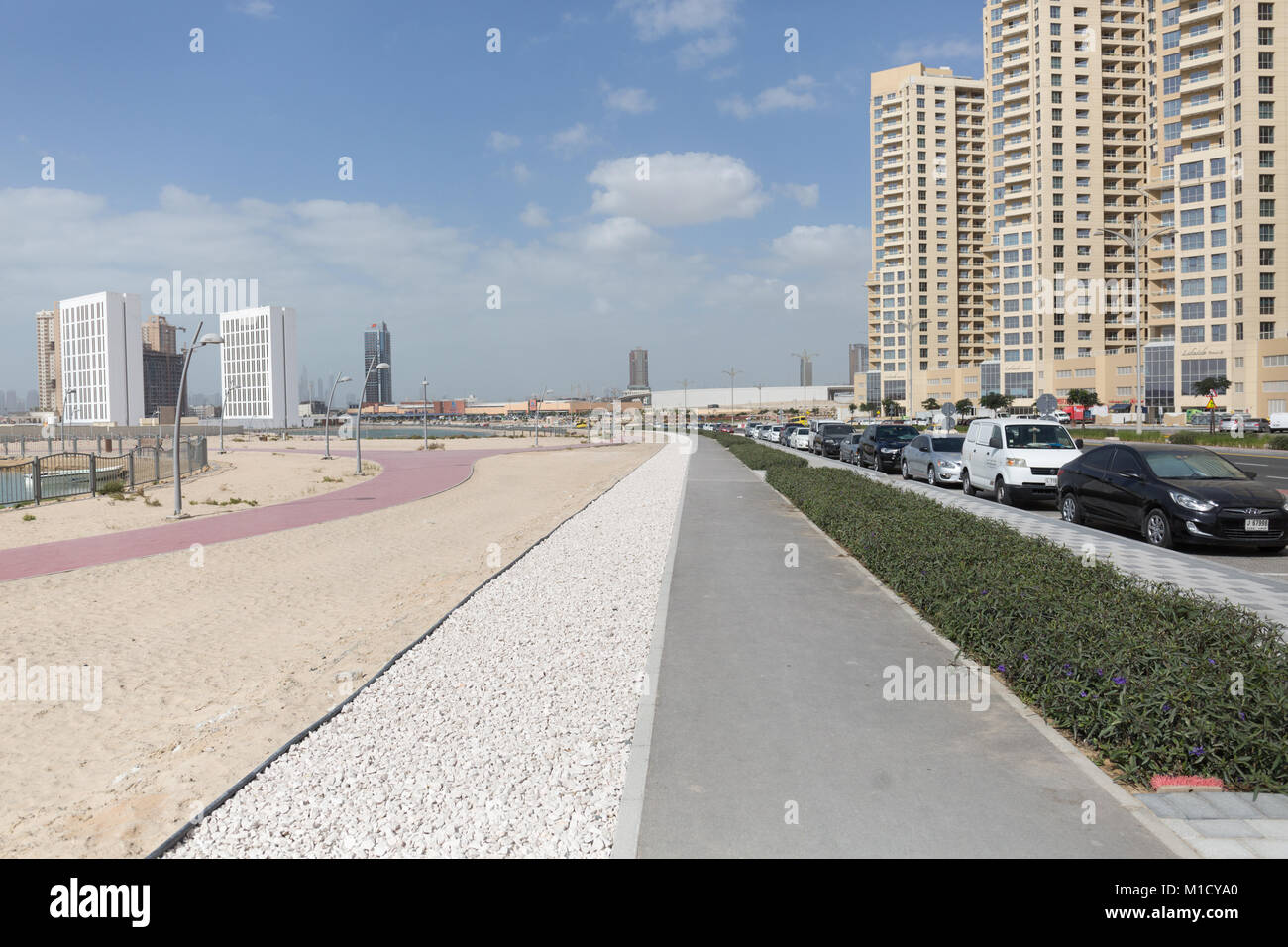 Jogging track and lake at IMPZ Dubai Stock Photo - Alamy