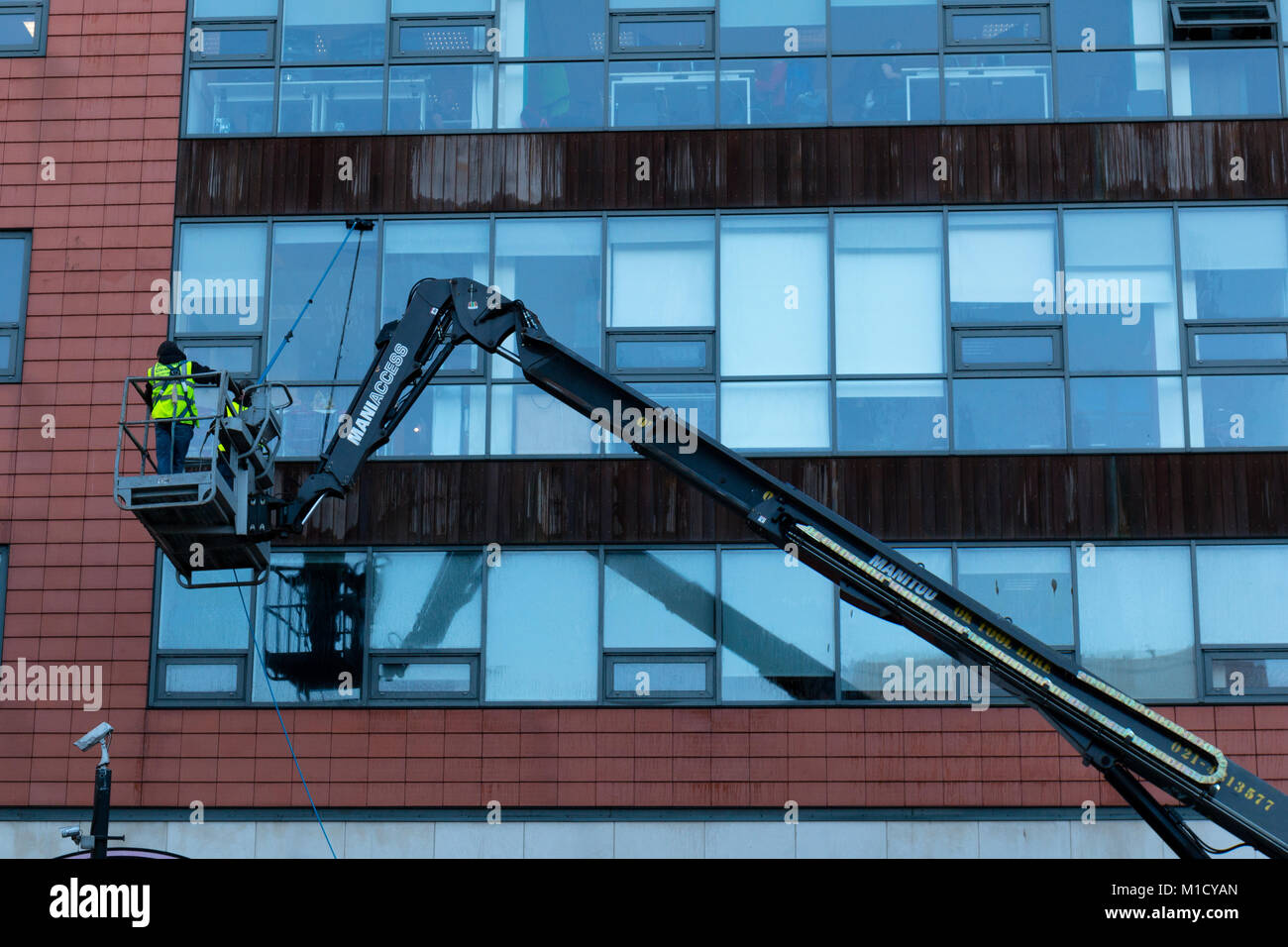 January 29th, 2018, Cork, Ireland - men doing high-rise window cleaning ...