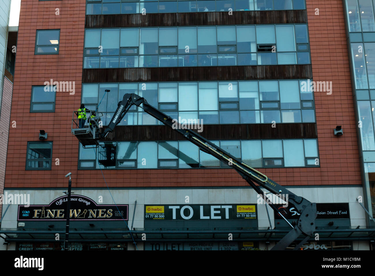 January 29th, 2018, Cork, Ireland - men doing high-rise window cleaning ...