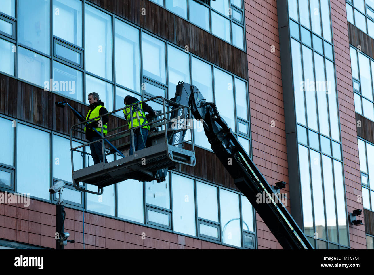 January 29th, 2018, Cork, Ireland - men doing high-rise window cleaning ...