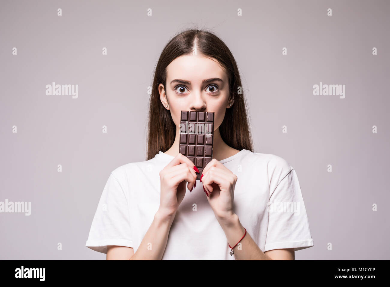 Attractive Young Woman Hiding Behind a Chocolate Bar Isolated On white ...